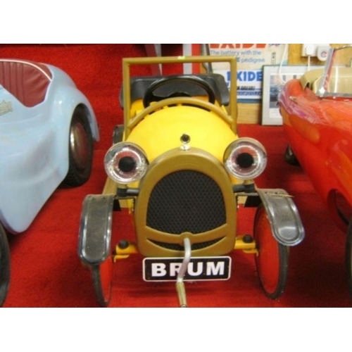 “Brum”, a yellow swing pedal car., Size 36” x 16”, having solid rubber ...
