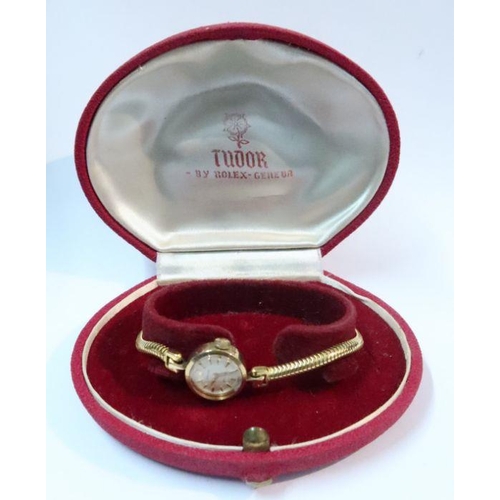 A 9ct gold cased Rolex lady's wrist watch, with 18ct gold snake link ...