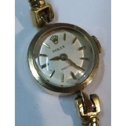 A 9ct gold cased Rolex lady's wrist watch, with 18ct gold snake link ...