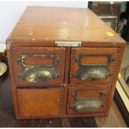 A wooden four drawer filing box, containing a collection of glass magic ...