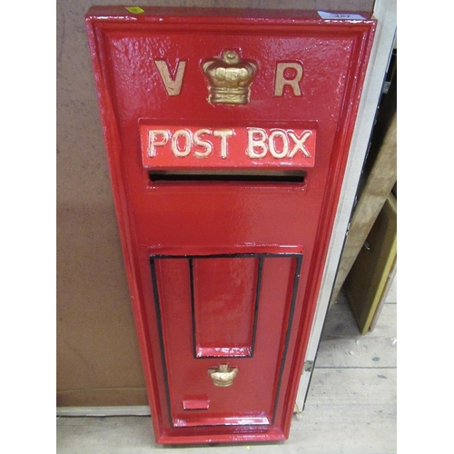 A painted mounted post box front
