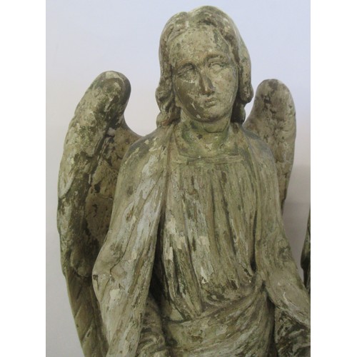A pair of antique carved winged religious figures, possibly limewood ...