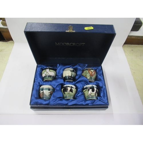 A boxed Moorcroft pottery set of six eggcups, all decorated with ...