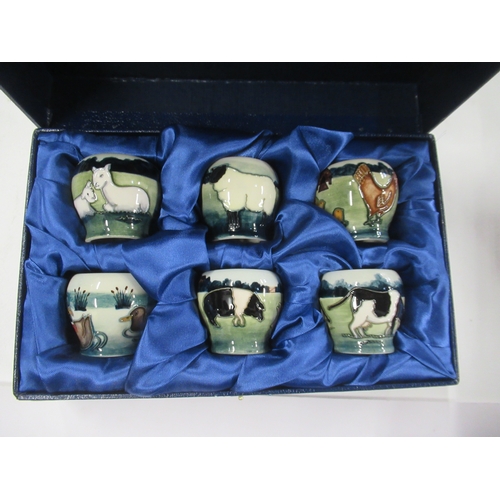 A boxed Moorcroft pottery set of six eggcups, all decorated with ...