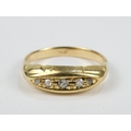 An 18ct gold and diamond set ring - with a five stone rub-over setting ...