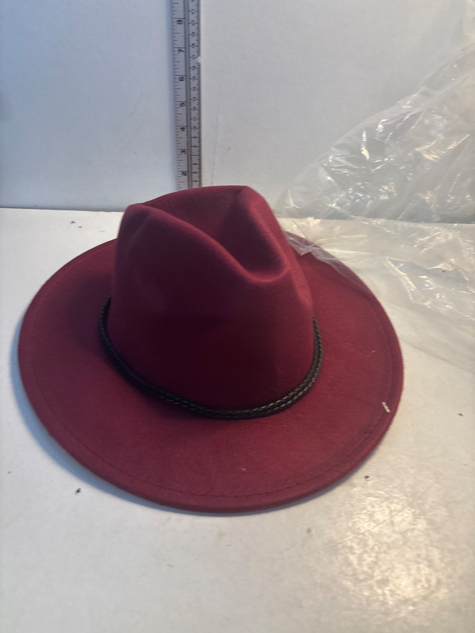 Red felt fedora hat with braided black band trim.