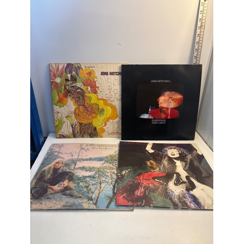 Four Joni Mitchell vinyl records with original covers.