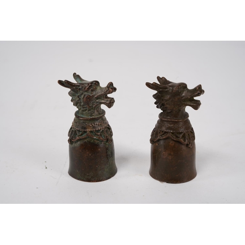 A pair of old bronze candle snuffer decorated with wolf head finials