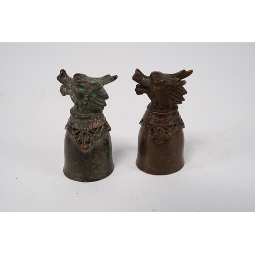 A pair of old bronze candle snuffer decorated with wolf head finials