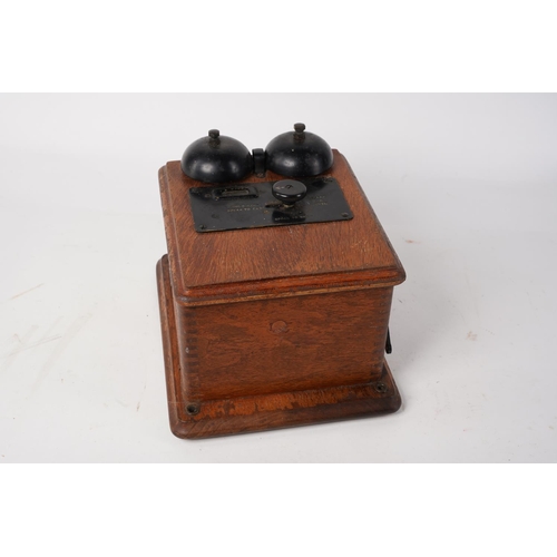 An antique wooden cased telephone unit (a/f).