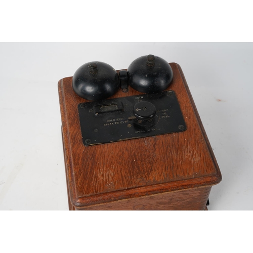 An antique wooden cased telephone unit (a/f).