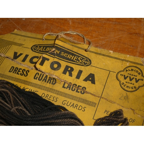 A vintage 'Victoria Dress Guard Laces' shop display card.
