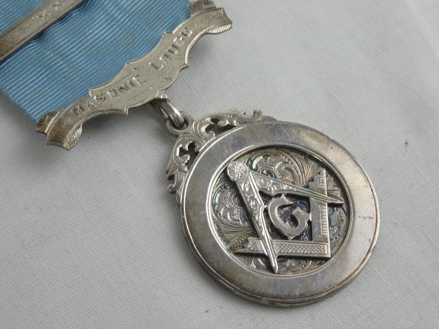A Sterling silver Masonic Lodge medal and ribbon presented to W Bro ...