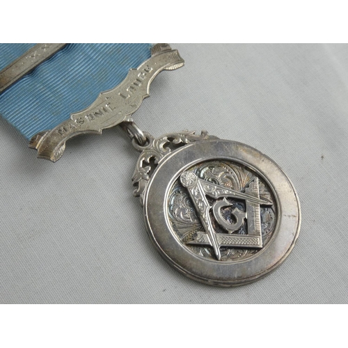 A Sterling silver Masonic Lodge medal and ribbon presented to W Bro ...