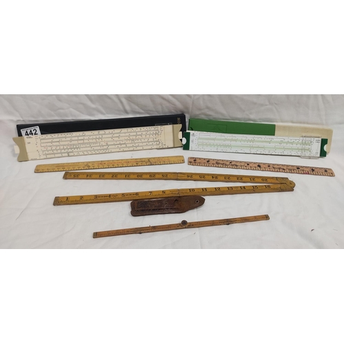 A lot of assorted vintage rulers including a leather cased 12" ruler.