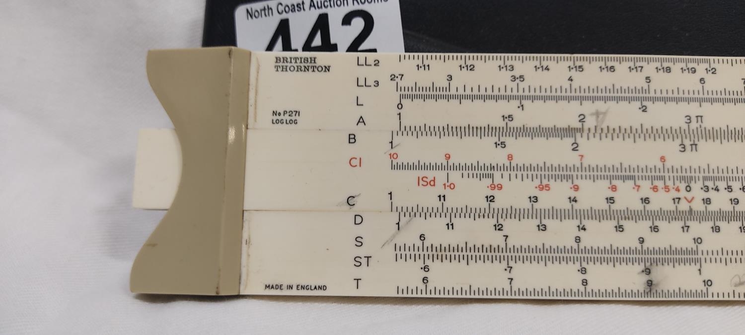 A lot of assorted vintage rulers including a leather cased 12" ruler.