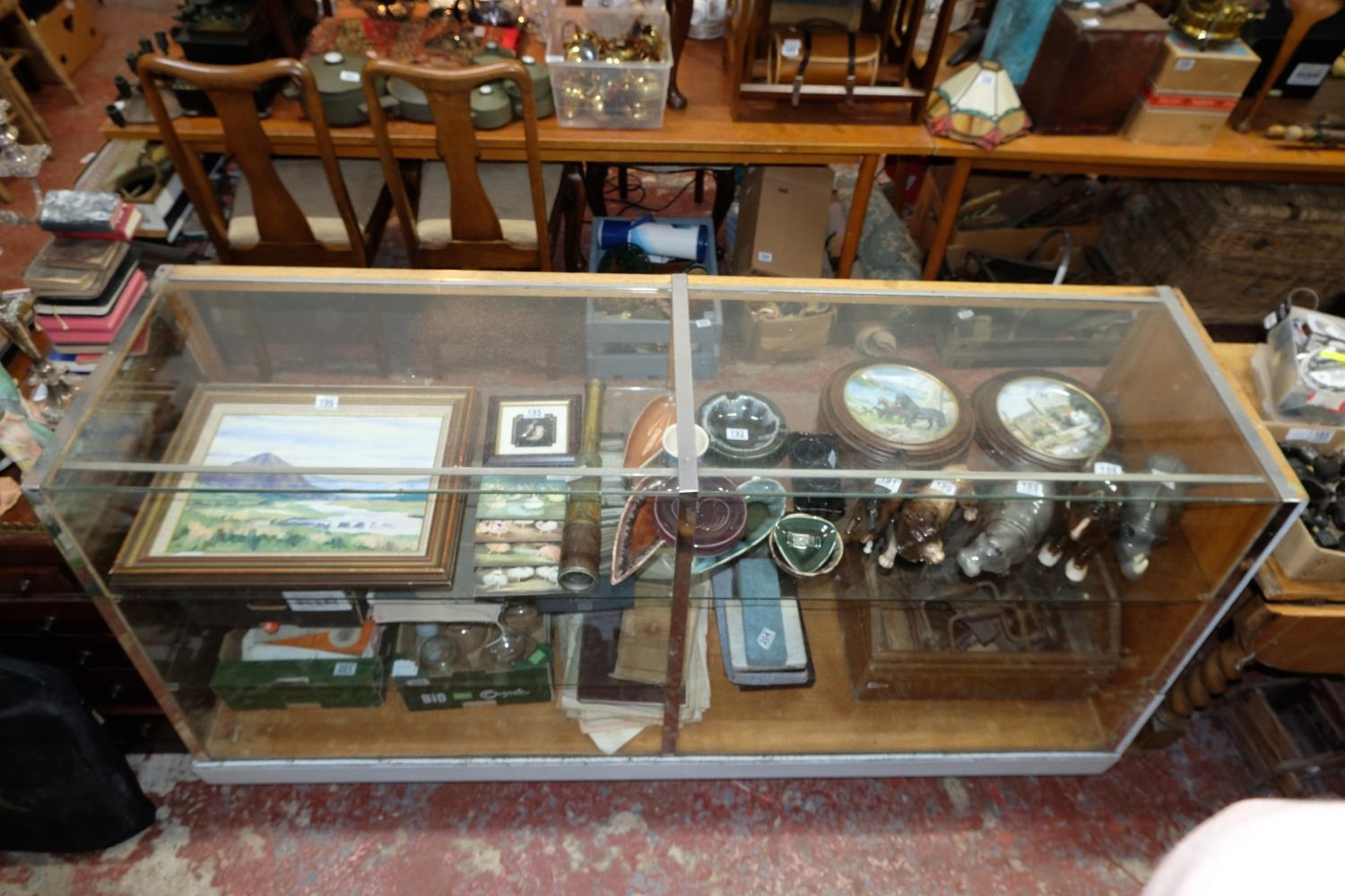 A stunning vintage shop display counter with glass shelves.