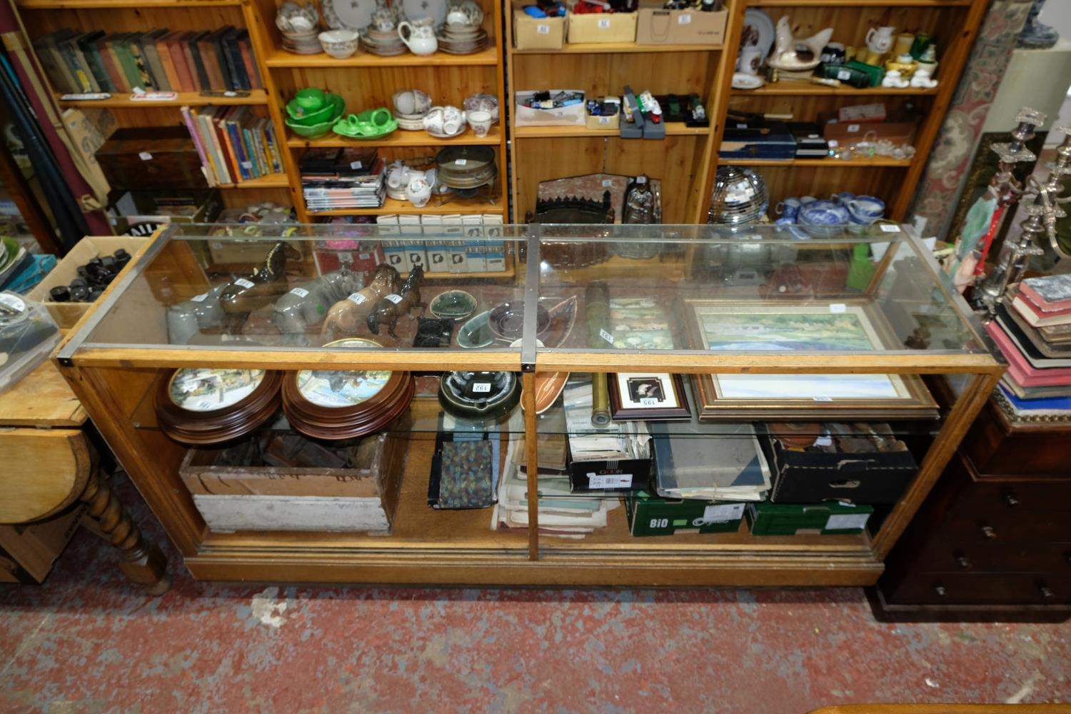 A stunning vintage shop display counter with glass shelves.