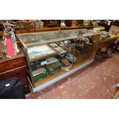 A stunning vintage shop display counter with glass shelves.