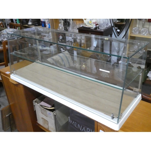 A counter top glass display cabinet with sliding doors to rear ...
