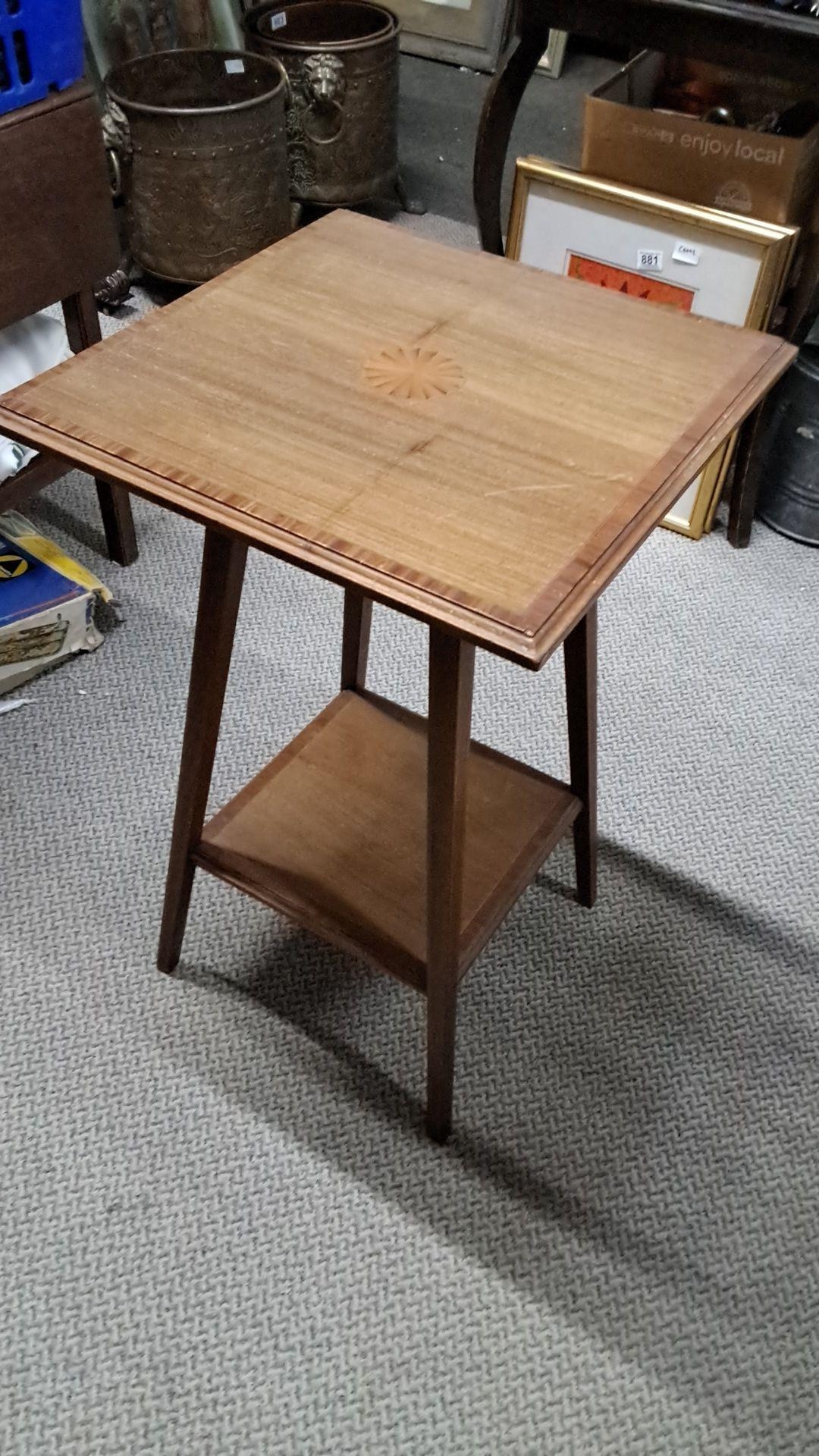An antique square wooden side table with inlaid starburst design on the ...