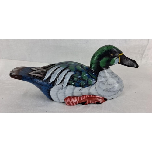 Pair of hand-painted wooden duck decoys, featuring vibrant colors.