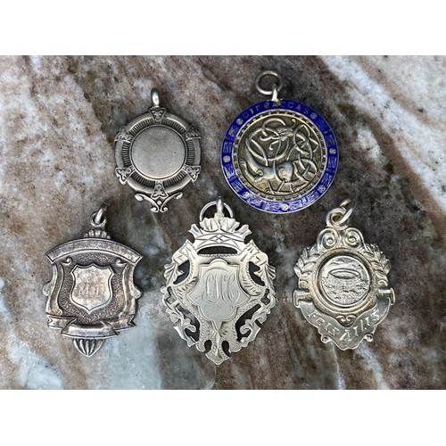 A collection of 5 antique Irish & Sterling Silver fobs.