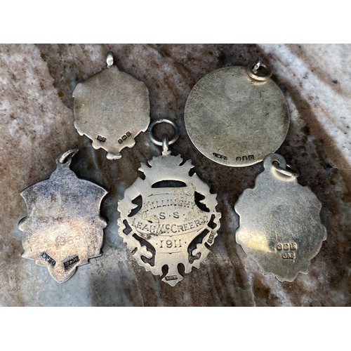 A collection of 5 antique Irish & Sterling Silver fobs.