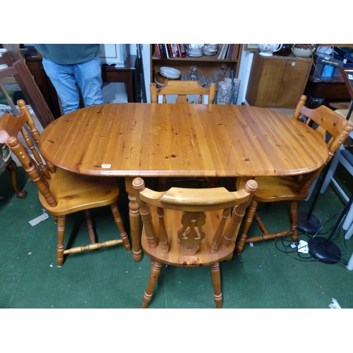 A pine extending dining table and matching chairs.