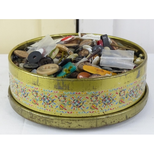 A vintage tin of assorted buttons.