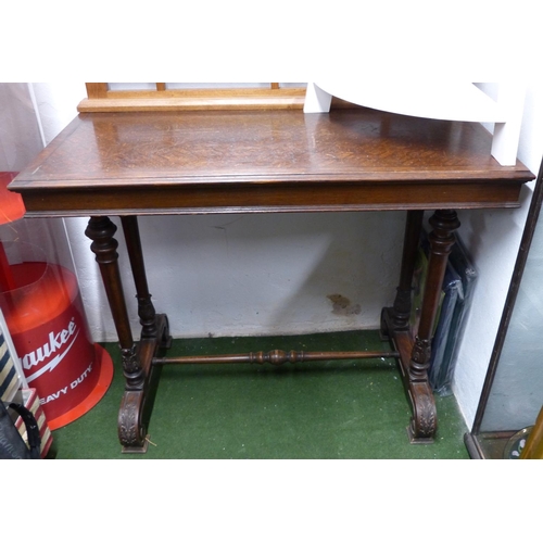 An antique mahogany library table with carved base.