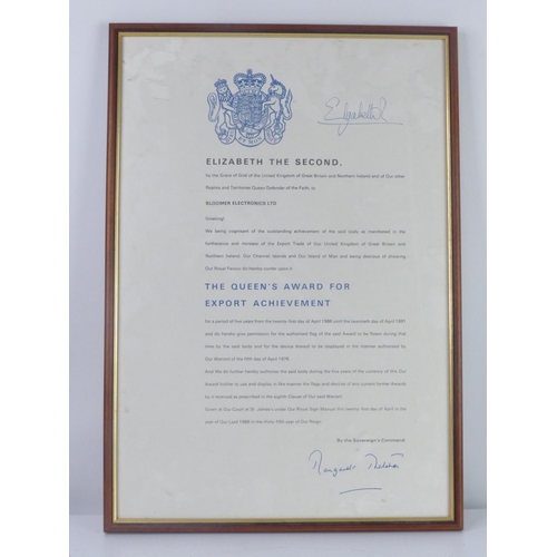 A framed 'Queen's Award for Export Achievement'.