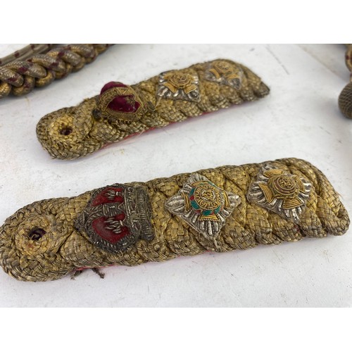 A pair of antique Regimental shoulder badges and belt.
