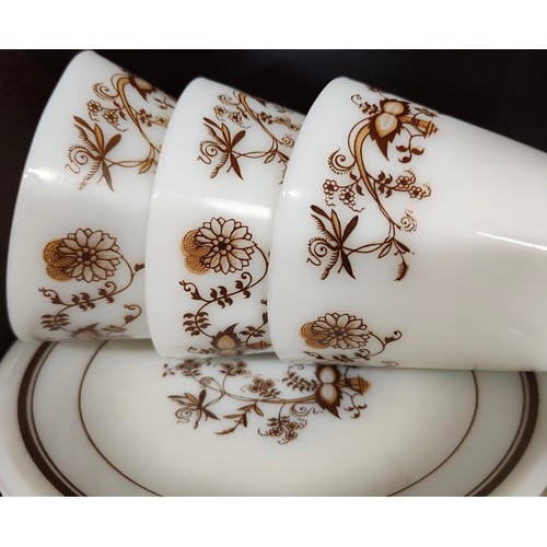 A vintage Pyrex tea set and dinner service with decorative design.