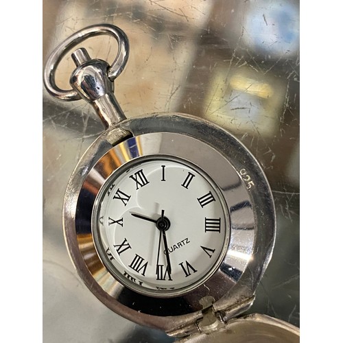 A Sterling silver quartz pendant pocket watch, engraved with the ...
