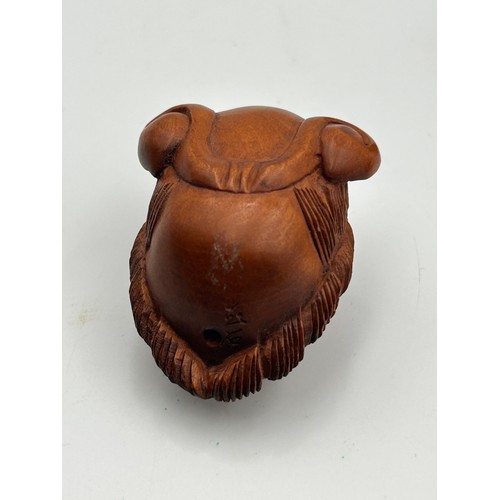 PAIR OF CARVED WOODEN FACE MASK NETSUKE AND A LUCKY TOAD CARVED WOODEN ...