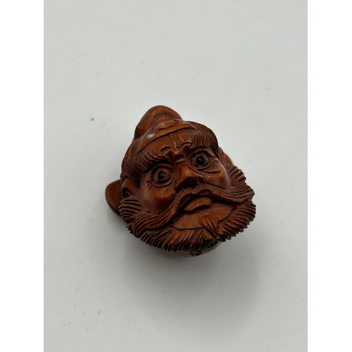 PAIR OF CARVED WOODEN FACE MASK NETSUKE AND A LUCKY TOAD CARVED WOODEN ...