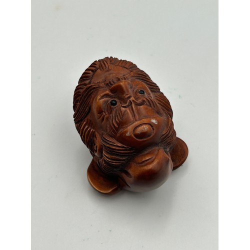 PAIR OF CARVED WOODEN FACE MASK NETSUKE AND A LUCKY TOAD CARVED WOODEN ...