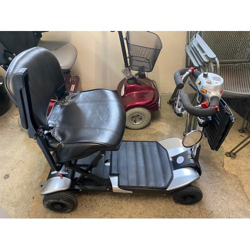 An Easy Living mobility scooter with key and charger and an Easy Living ...