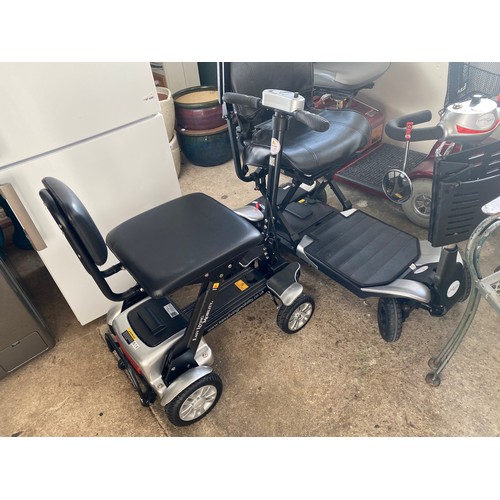 An Easy Living mobility scooter with key and charger and an Easy Living ...