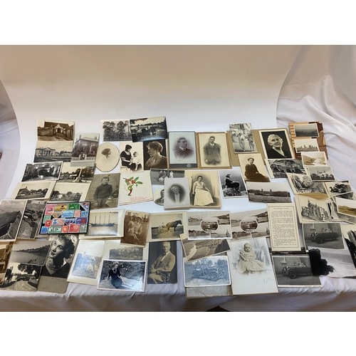 A blue postcard album and a selection of loose postcards various