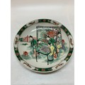 A Chinese Kangshi style dish decorated in famille verte with figures to ...
