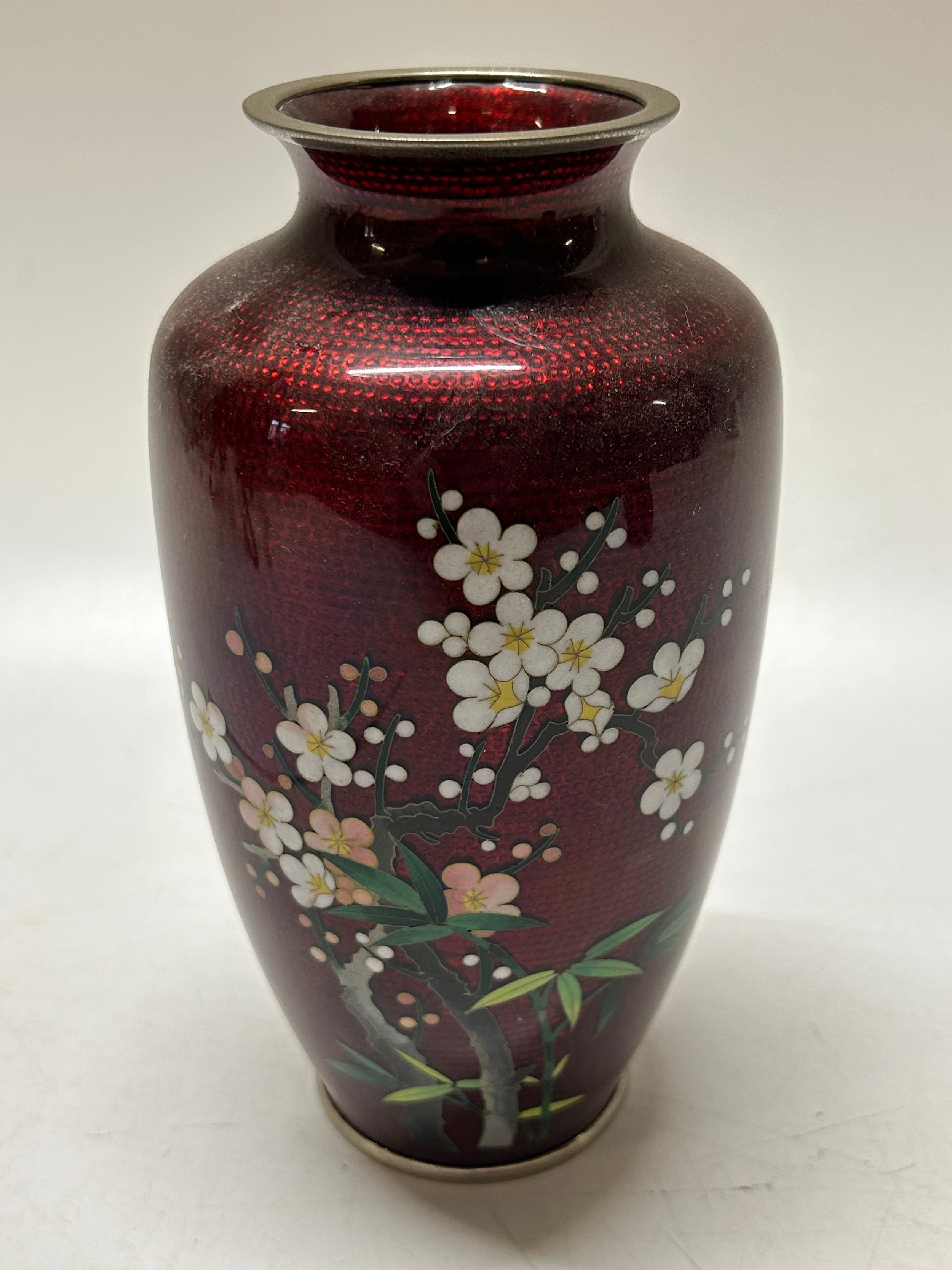 A Cloisonne vase, red decorated decorated prunus and bamboo - 7 1/2in. high