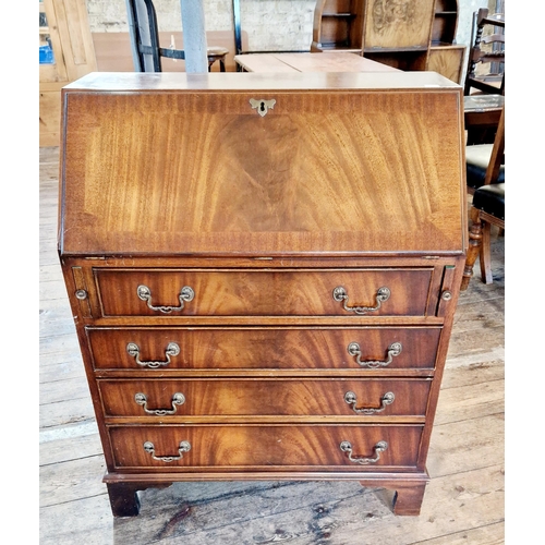 Reproduction mahogany bureau with fitted interior over a base of four ...