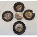 Four framed Victorian ceramic decorative pot lids plus a complete pot