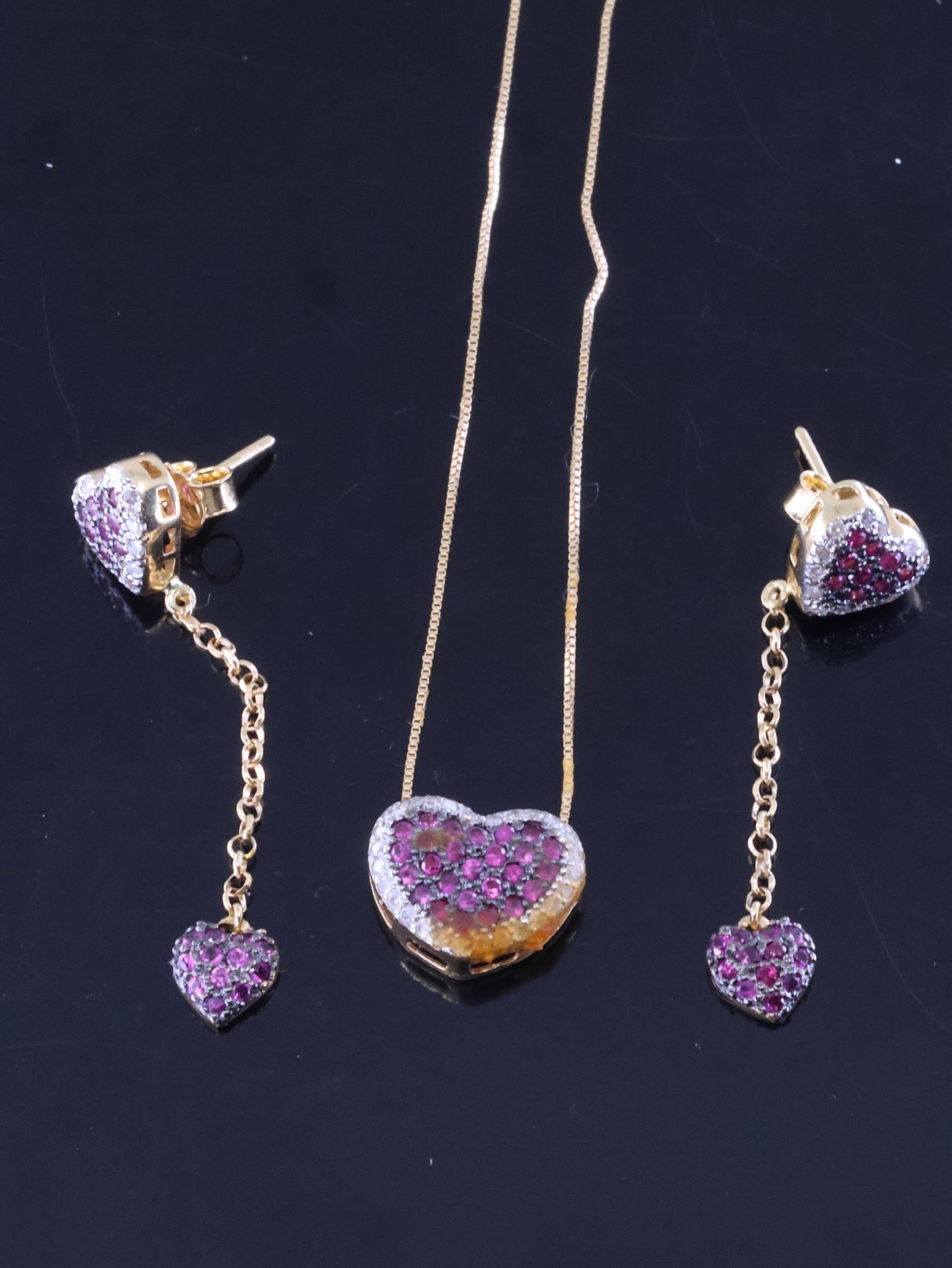 An 18ct gold diamond pendent and chain and earrings set