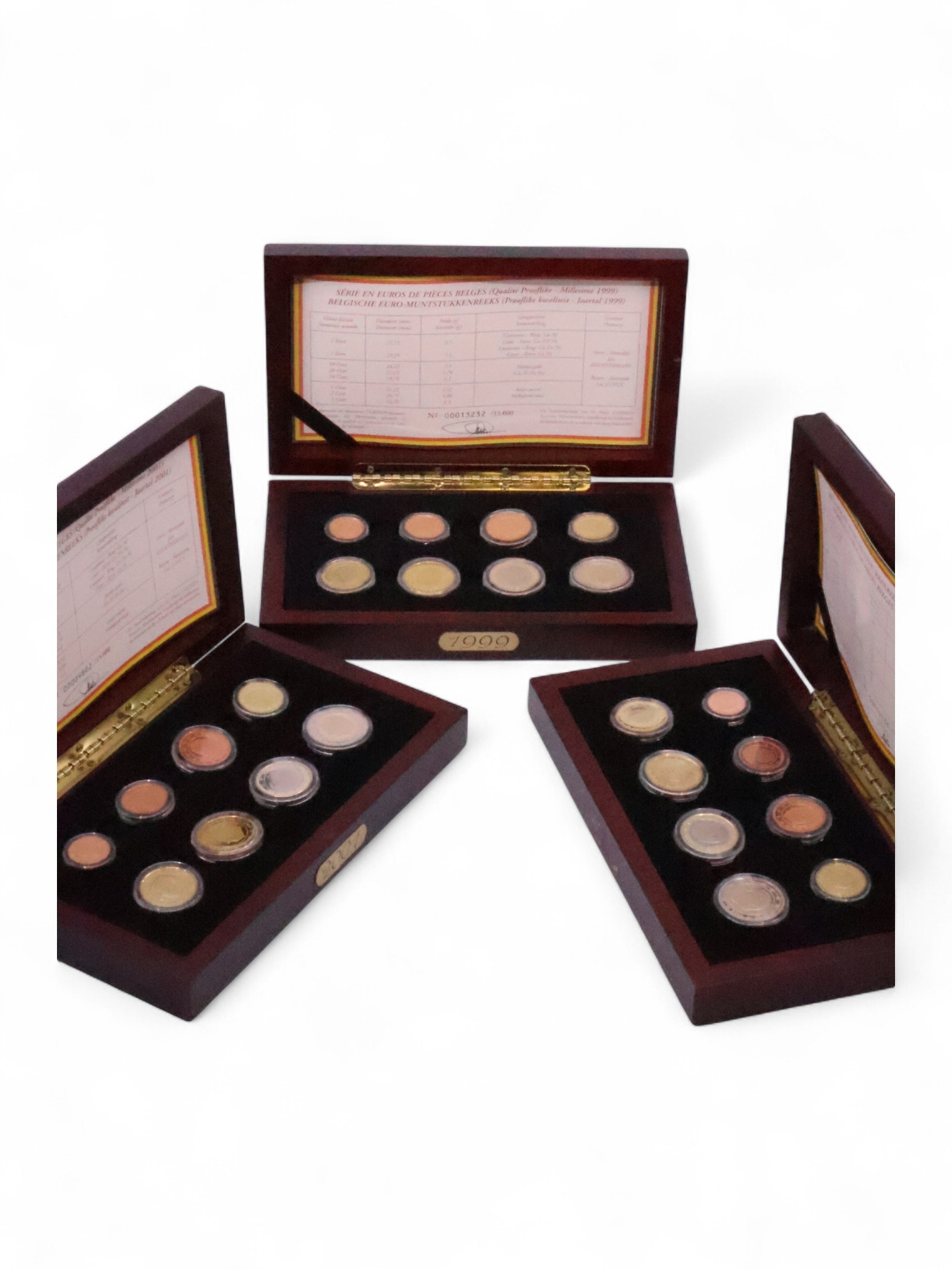 Three Finnish euro coins set in boxes