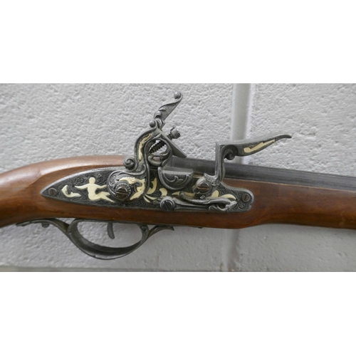 An ornate composite rifle, a flintlock rifle with brass butt, holster ...
