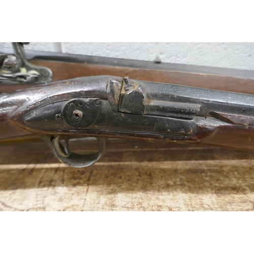 An ornate composite rifle, a flintlock rifle with brass butt, holster ...