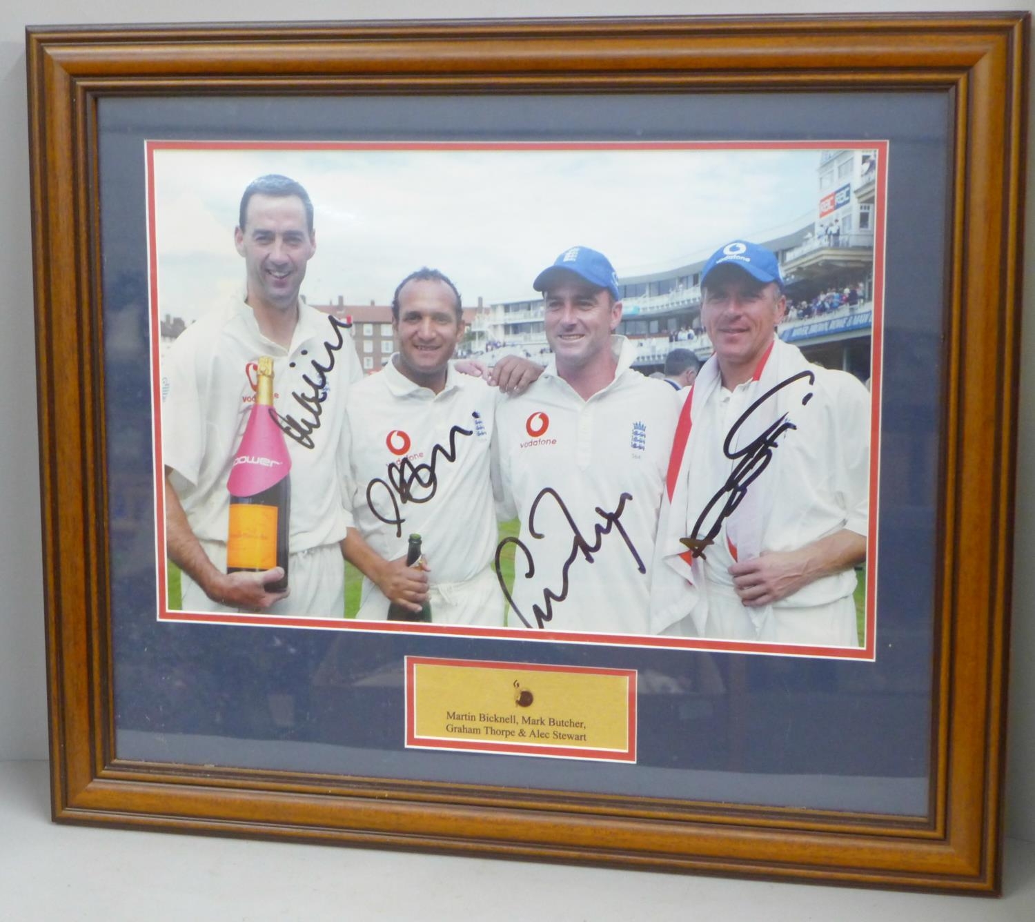 A framed and mounted picture, signed by four England players; Martin ...
